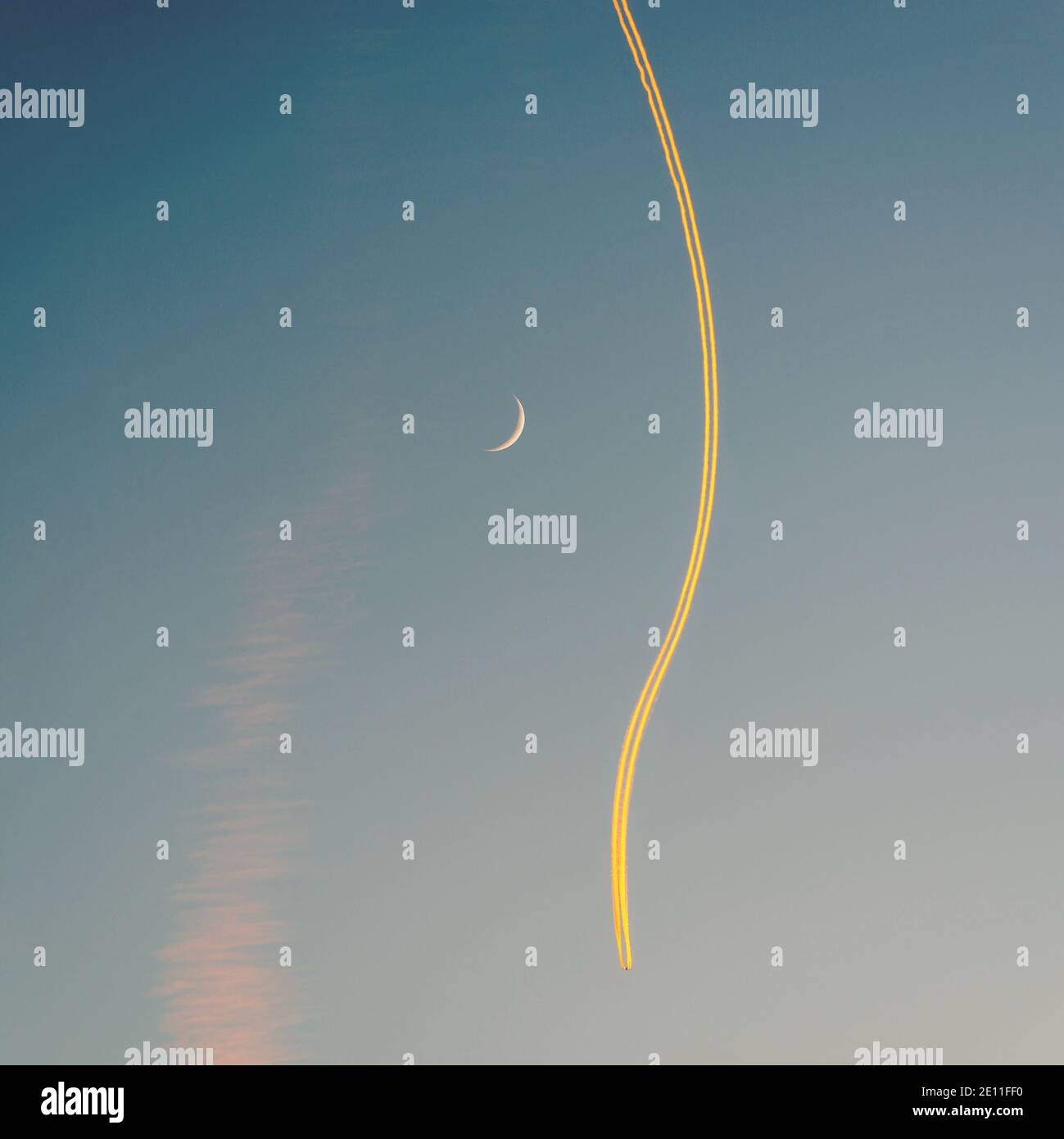 Jet airplane, its contrail and a crescent moon at sunset. The plane ...