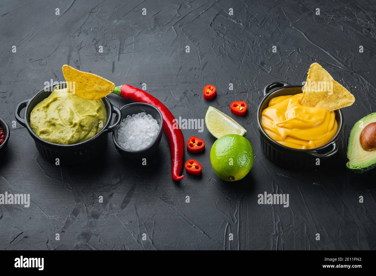 Green guacamole and yellow cheese dip sauce for traditional, Mexican ...