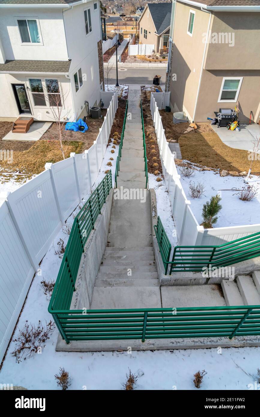 Aerial view of outdoor stairs at a neighborhood with houses and snowy ...