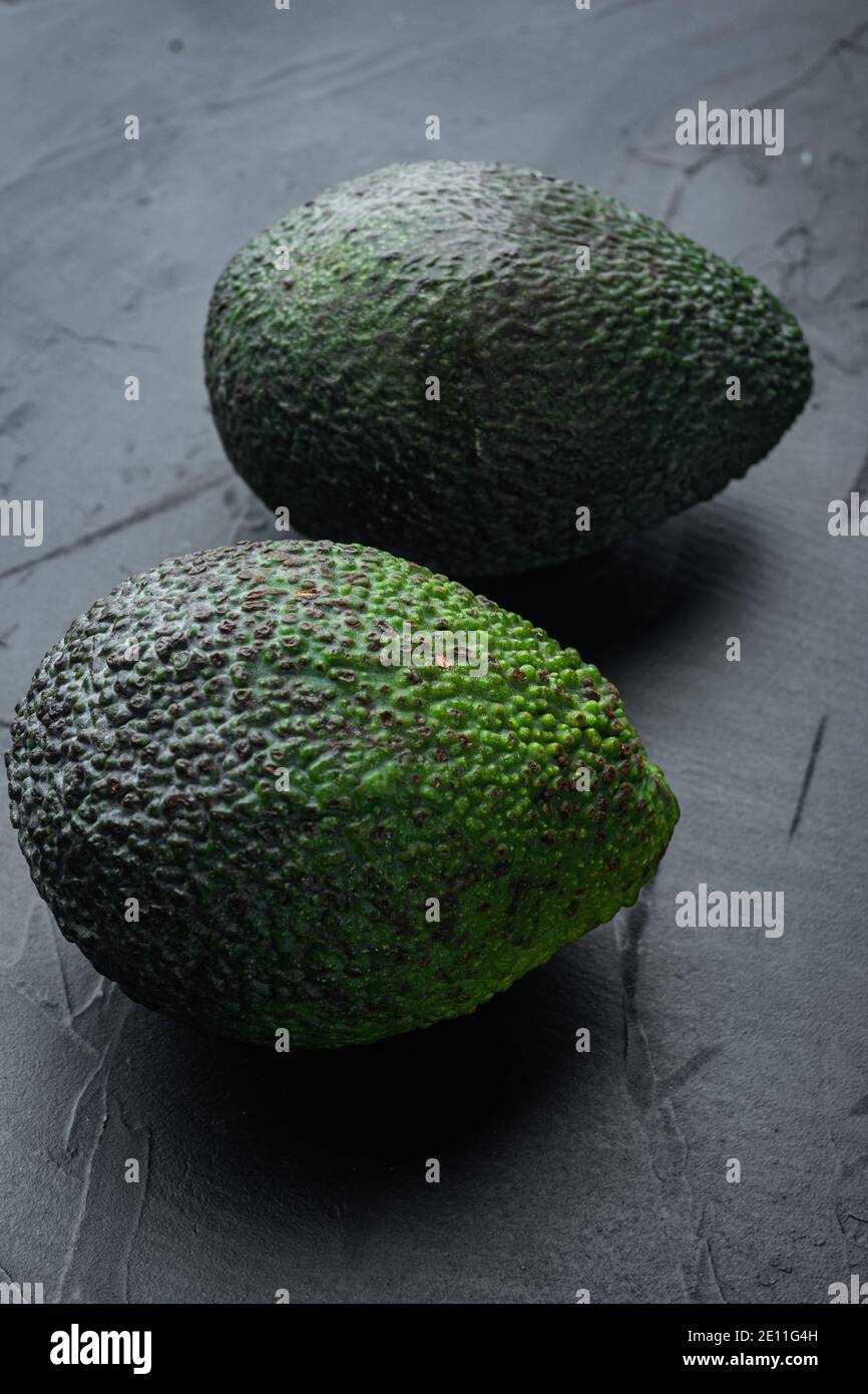 Whole pair of green avocado set, on black background Stock Photo - Alamy