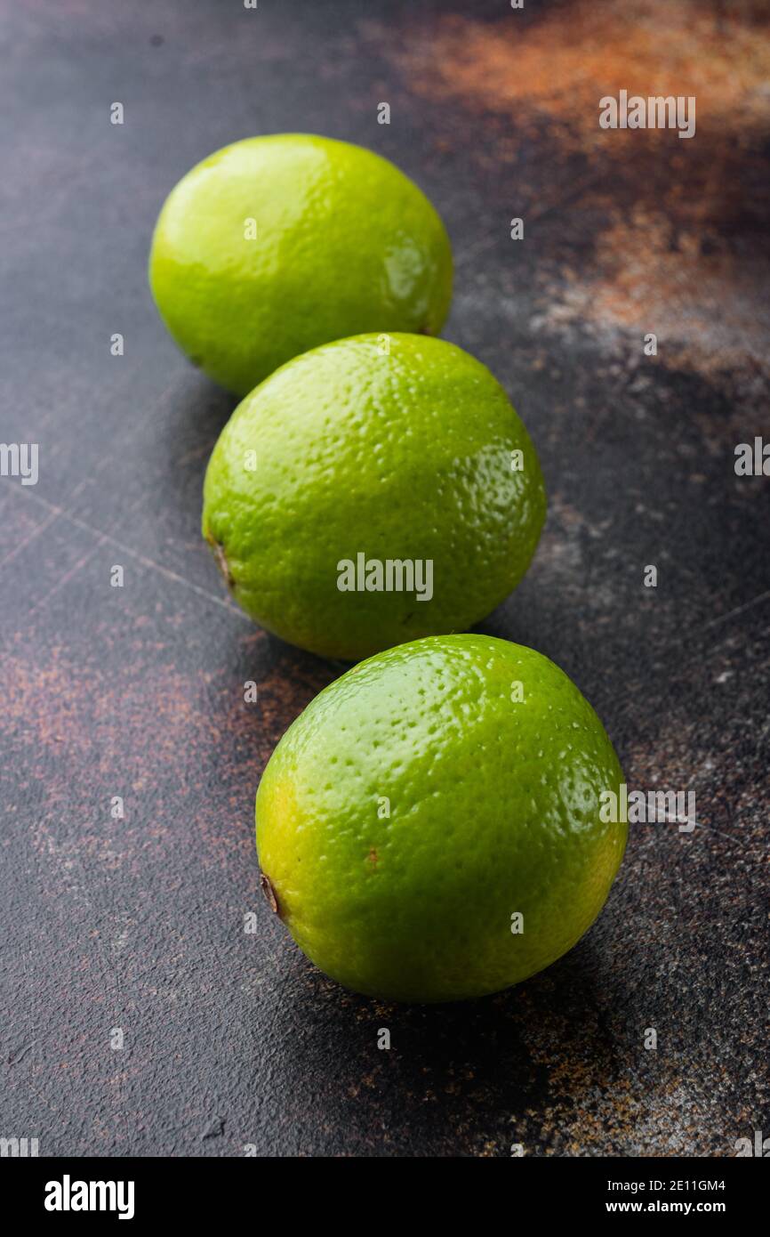 Whole green lime set, on old dark rustic background Stock Photo - Alamy