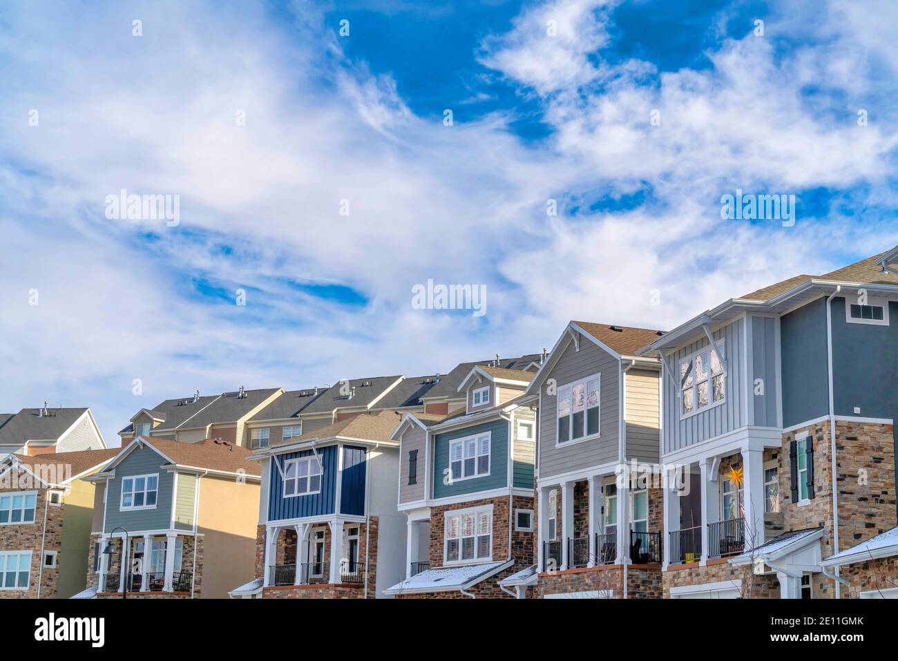 Homes in the valley on a sunny day setting beneath vibrant blue sky and ...