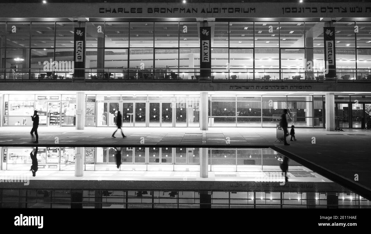 Few people outside the concert hall building during night time Stock ...