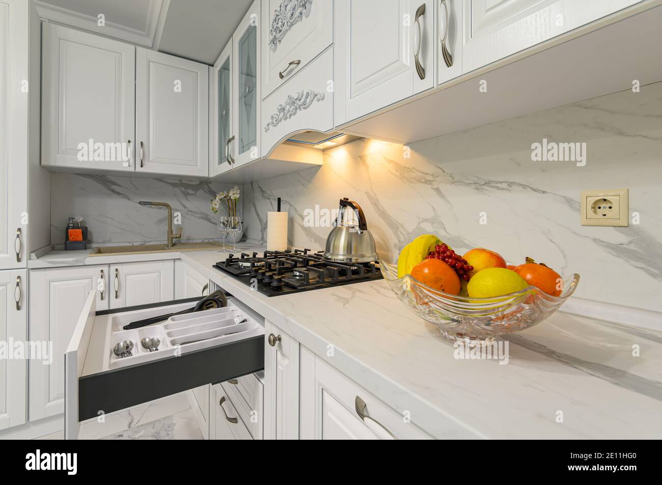 Open drawers with kitchenware at modern white kitchen Stock Photo - Alamy