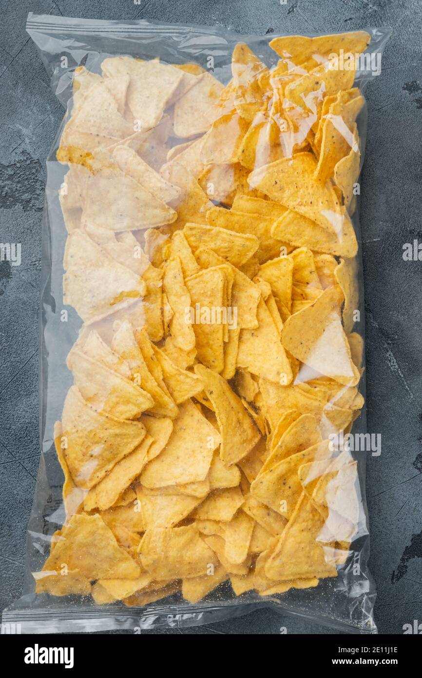 Packed and seasoned nachos and snack pack, on gray background, top view ...