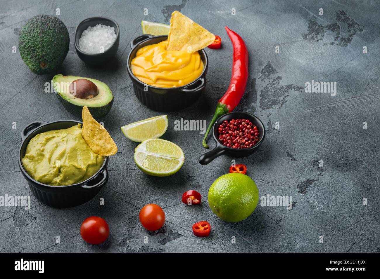 Green guacamole and yellow cheese dip sauce for traditional, Mexican ...