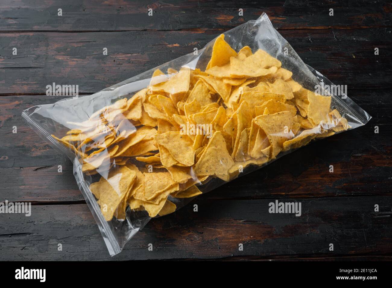 Nachos, corn tortilla in bag, on old wooden table Stock Photo - Alamy