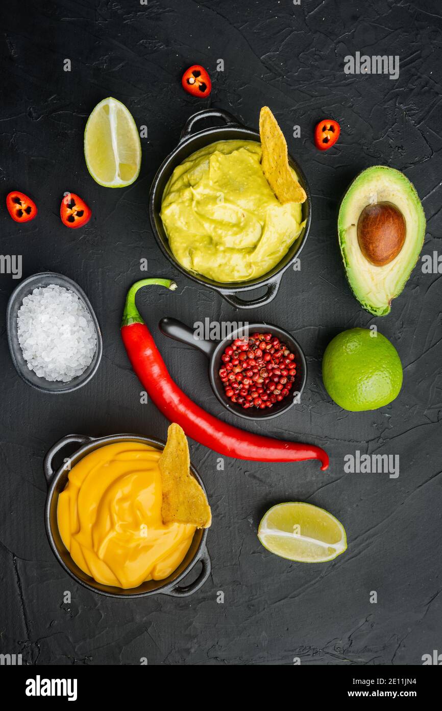 Green guacamole and yellow cheese dip sauce for traditional, Mexican ...
