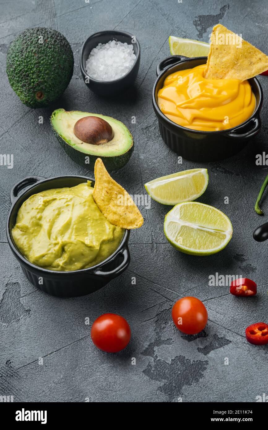 Green guacamole and yellow cheese dip sauce for traditional, Mexican ...