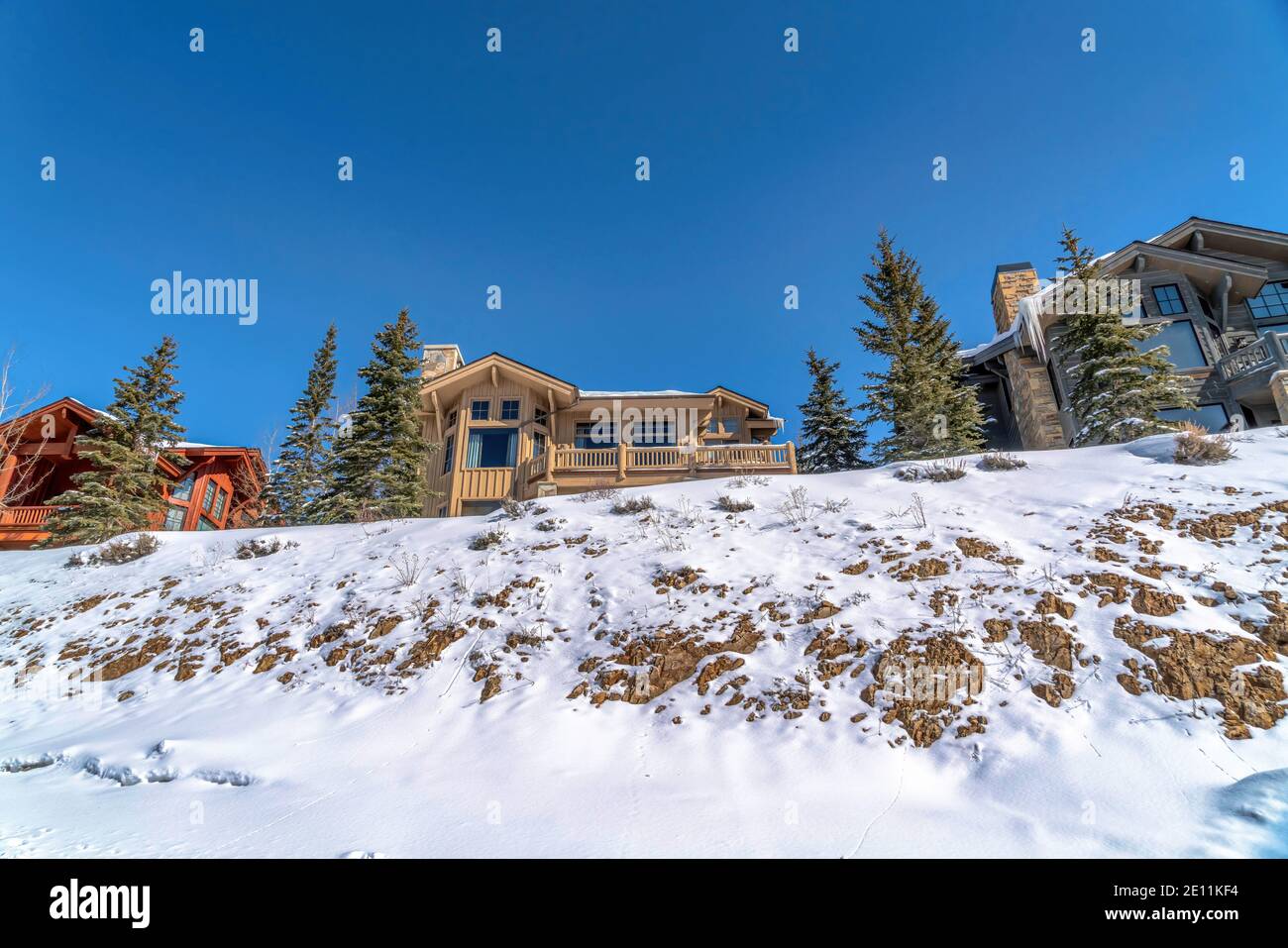 Mountain houses viewed from the bottom of the slope covered with snow ...