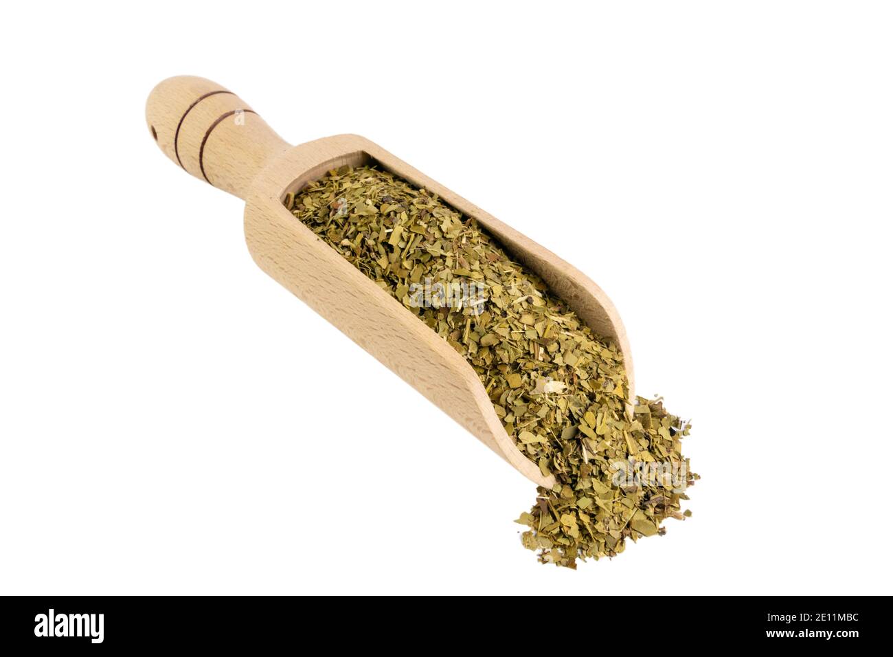 Dried leaves of yerba mate tea in wooden scoop isolated on white ...