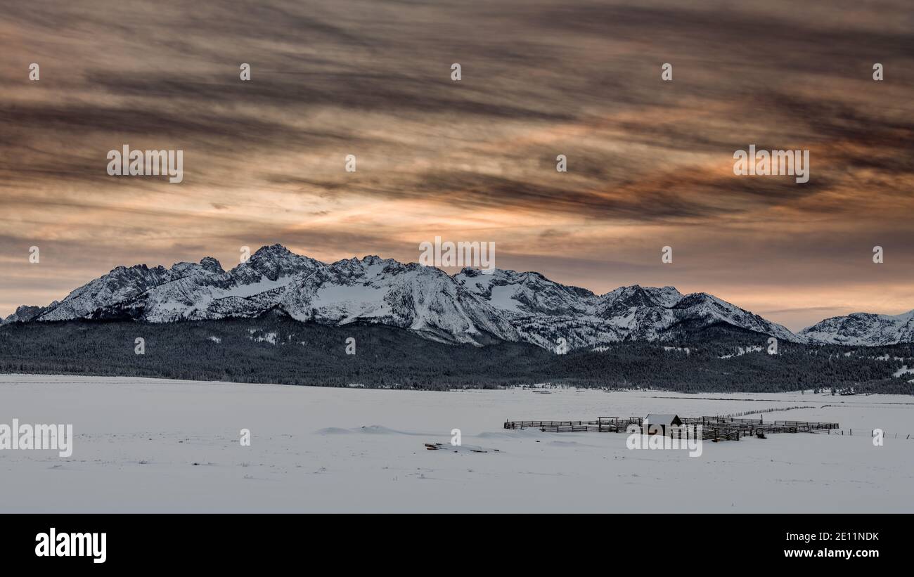 Snow covered field and distant mountain range Stock Photo - Alamy