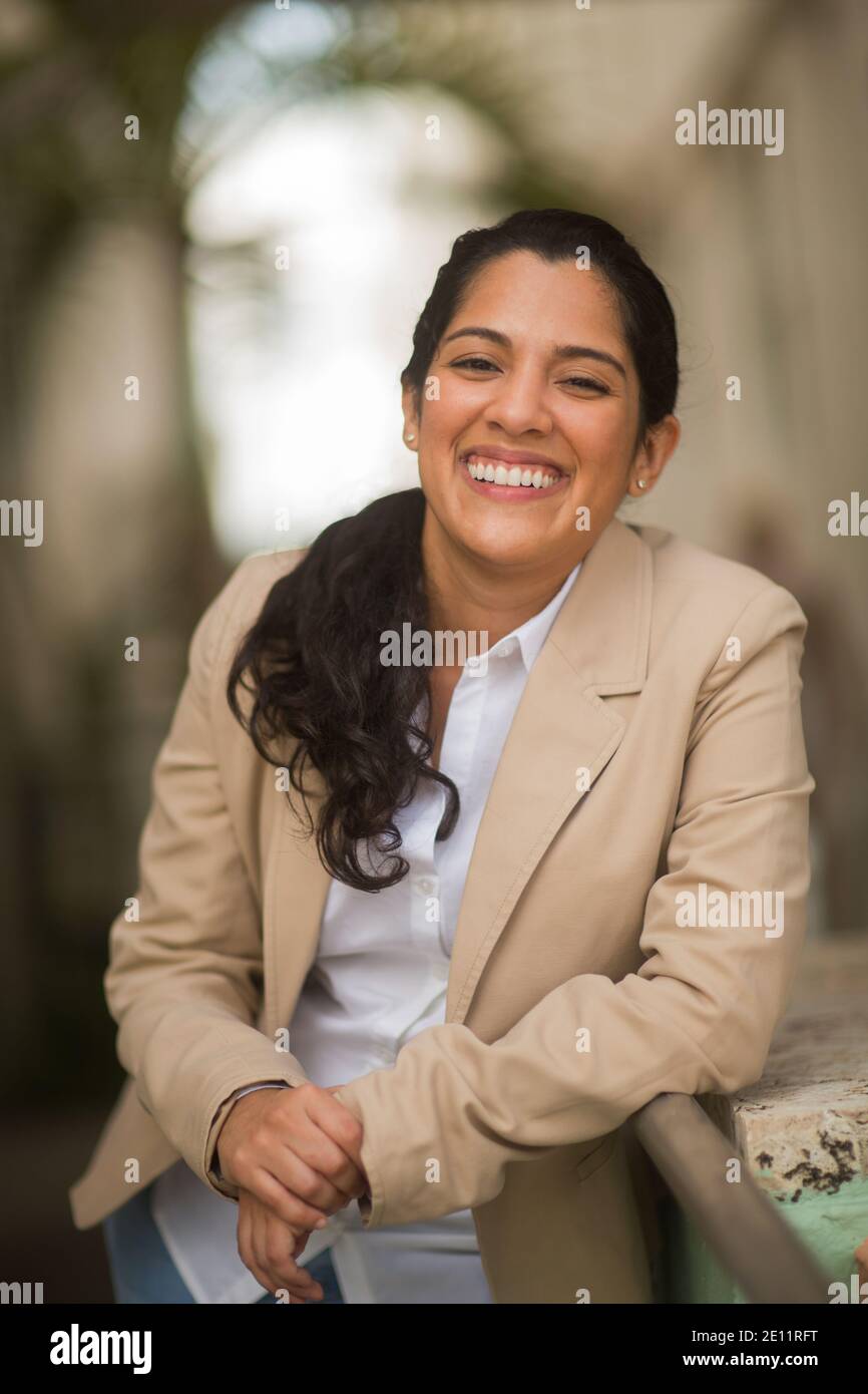 Hispanic business woman smiling outside stock photo Stock Photo - Alamy