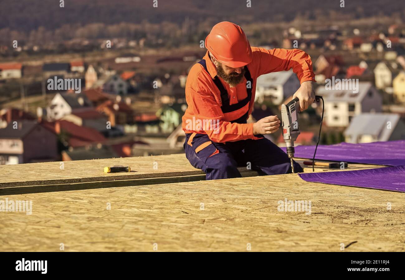 Master repair roof. Flat roof installation. Roofer constructing roof ...