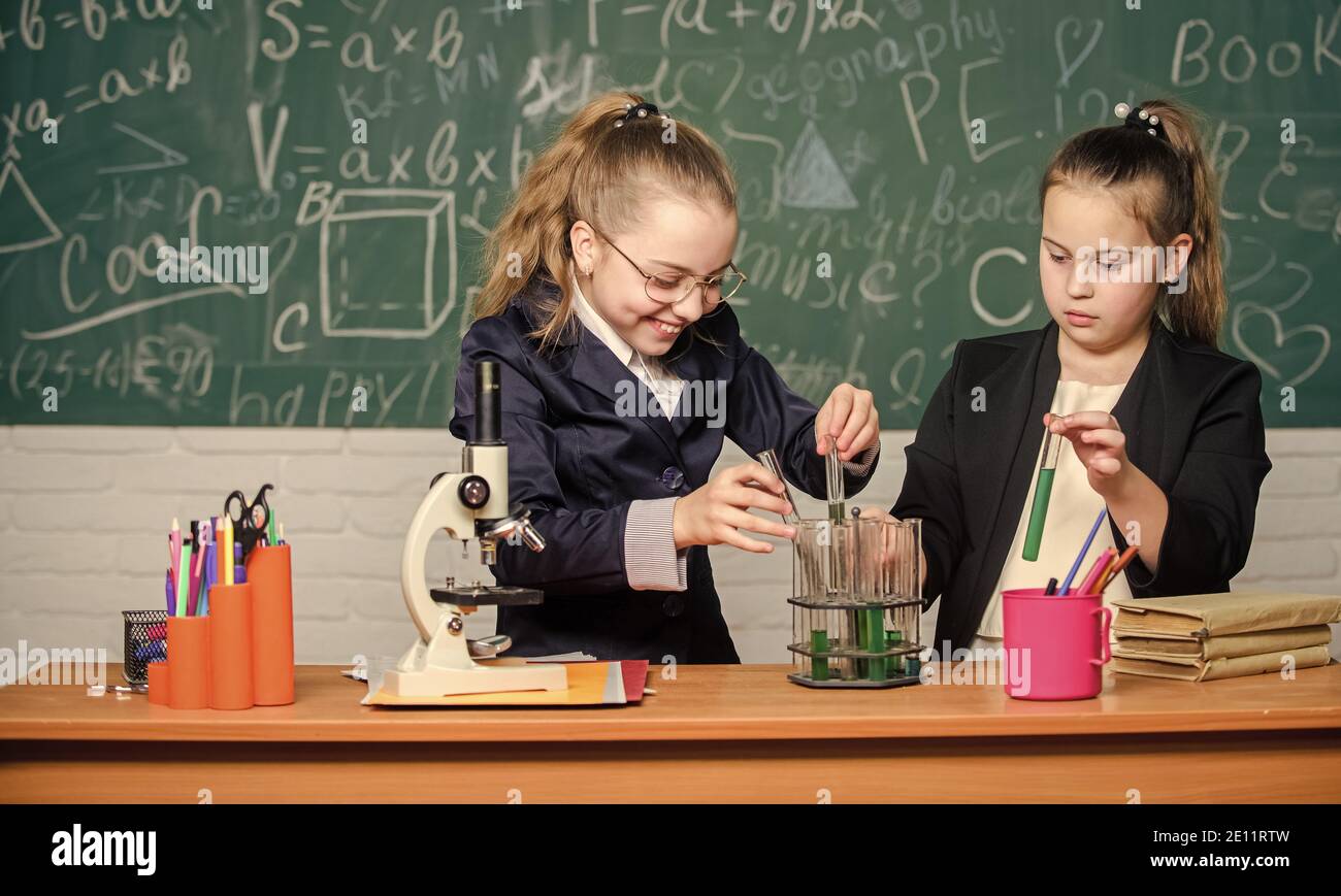 Little scientist work with microscope. Little girls in school lab ...