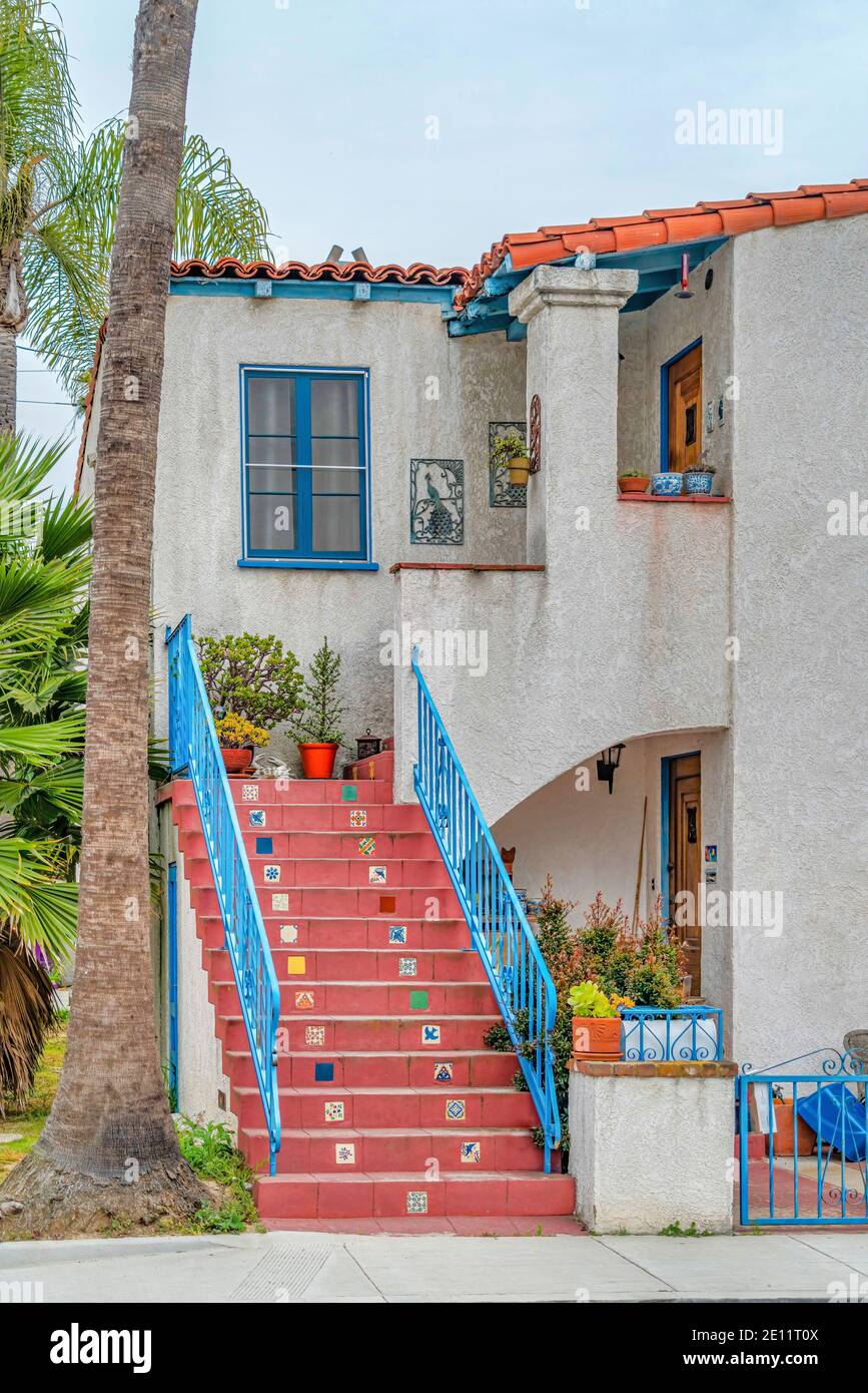 Red stairs with blue handrails at the facade of house in Long Beach ...