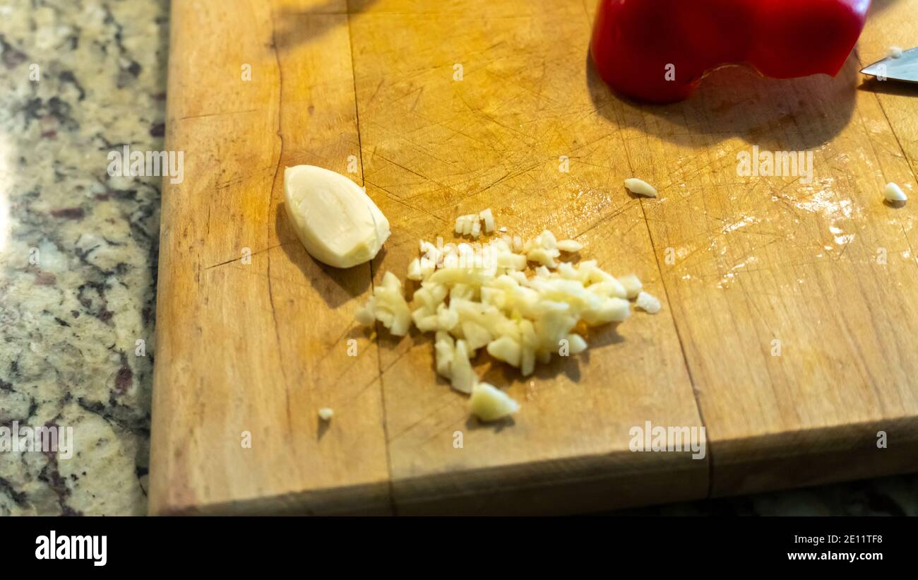Side View of Garlic Clove on Wooden Board Stock Photo - Alamy
