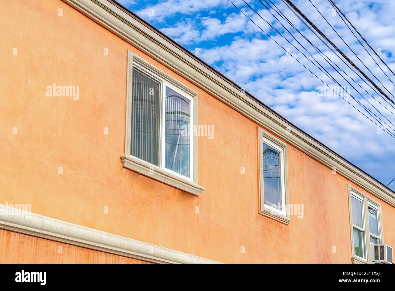 Windows and orange wall of building with flat roof in Huntington Beach ...