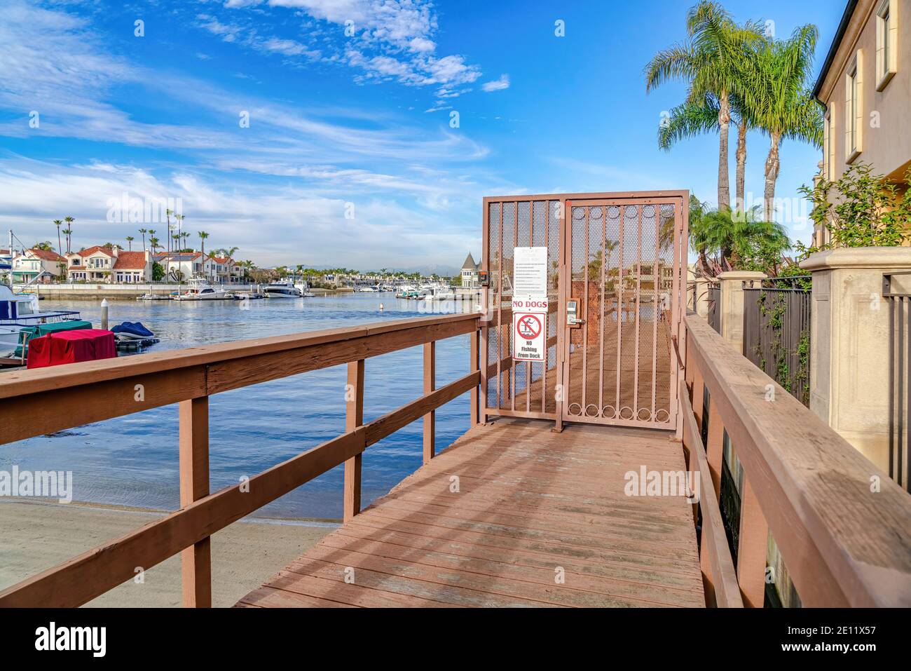 Dock with gate and warning signs against sea and blue sky in Huntington ...