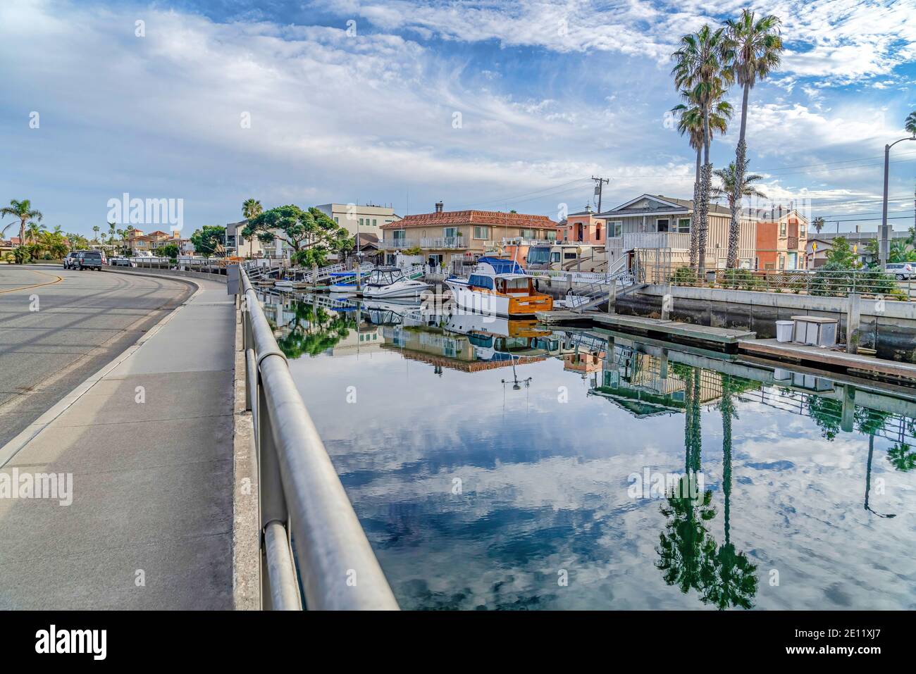 Road and canal with waterfront homes in scenic neighborhood of ...