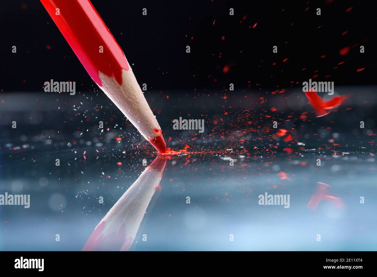 A red crayon damaged by pressure on glass while learning to draw or ...