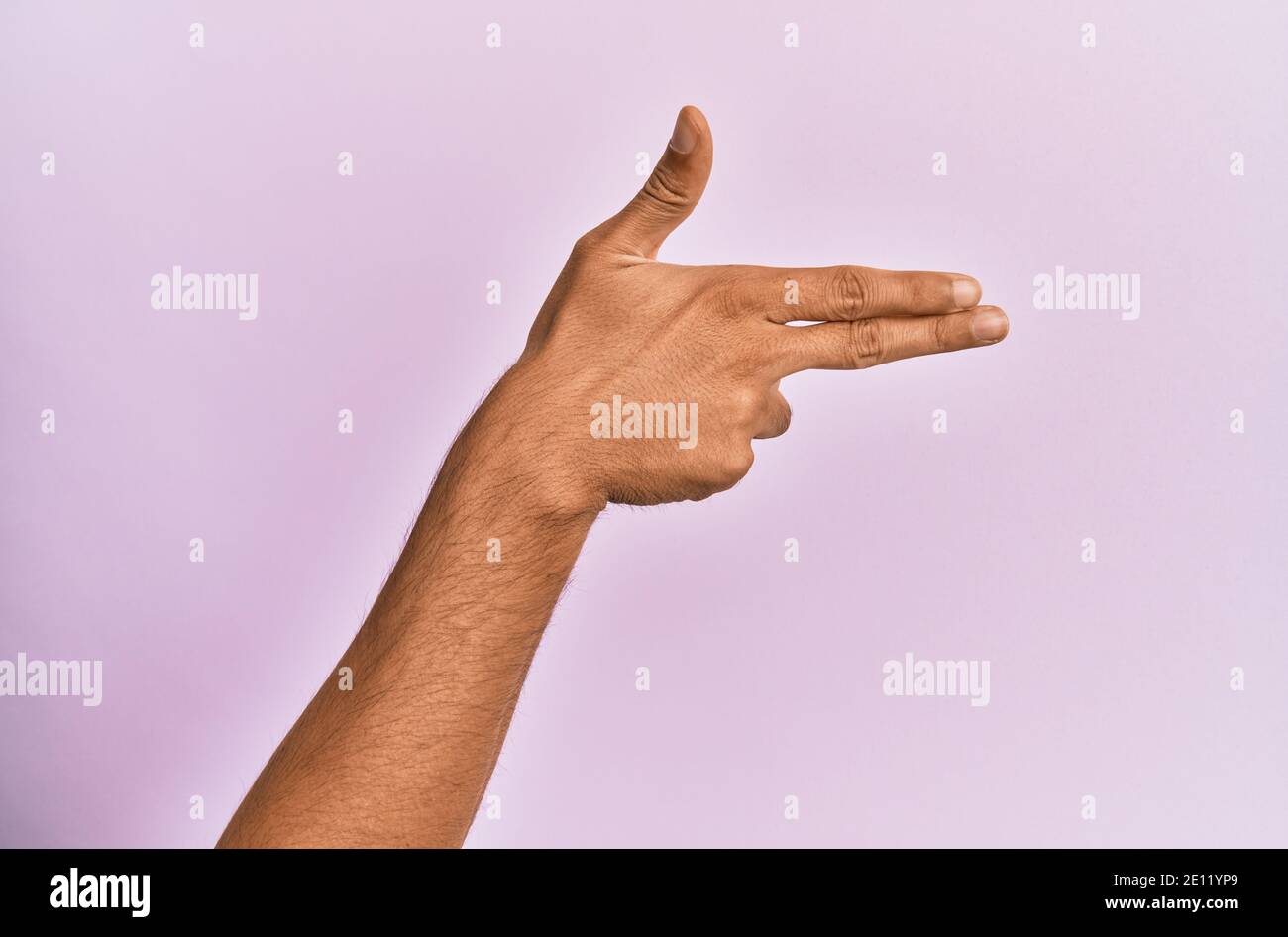 Arm and hand of caucasian young man over pink isolated background ...
