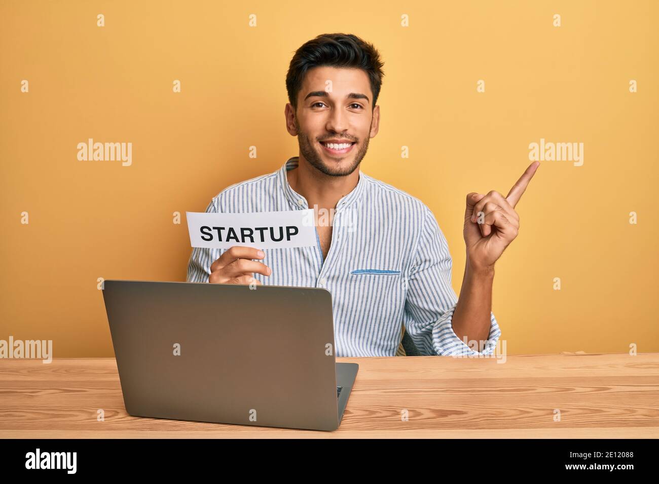 Young handsome man holding startup message as marketing development ...