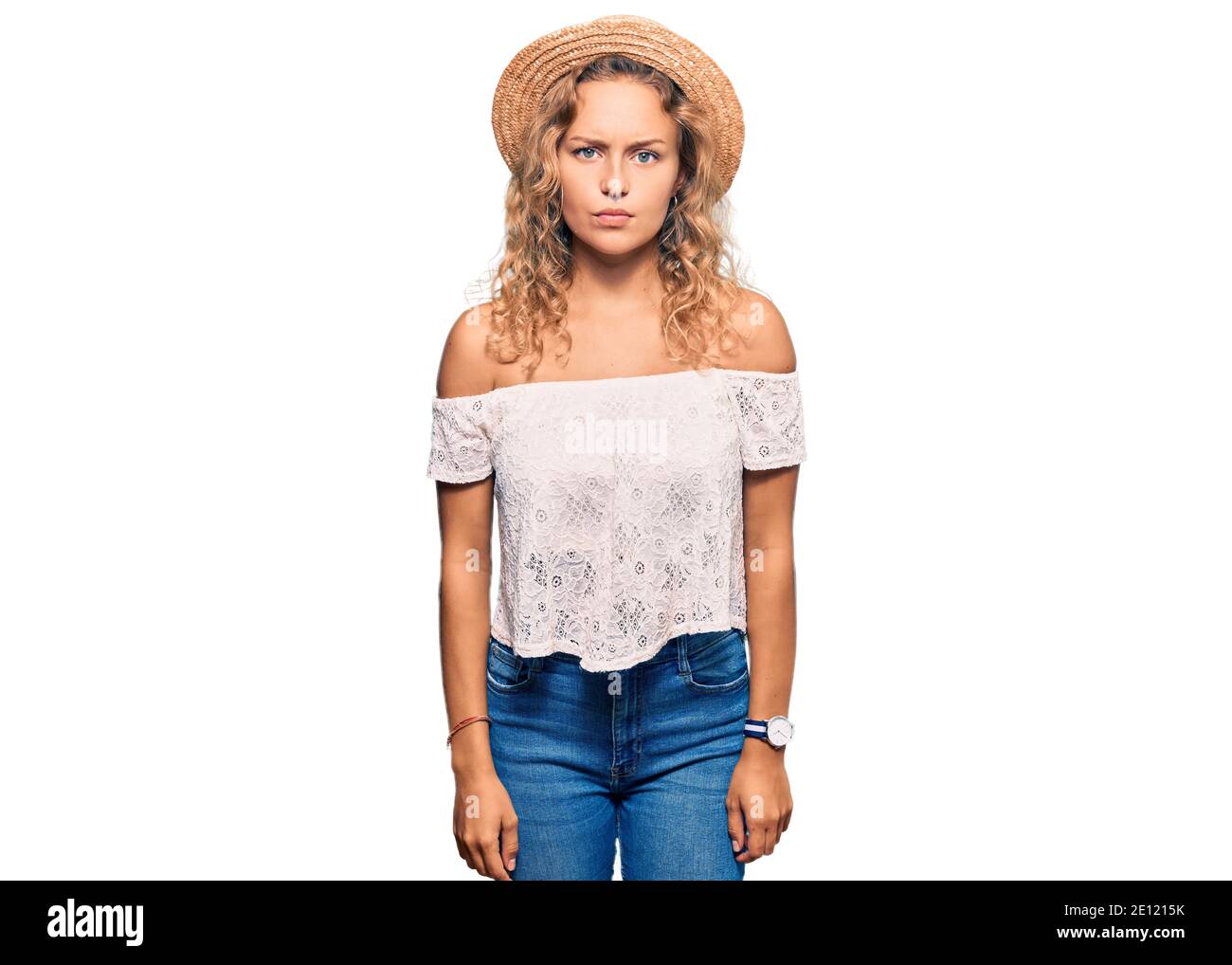Beautiful caucasian woman wearing summer hat skeptic and nervous ...