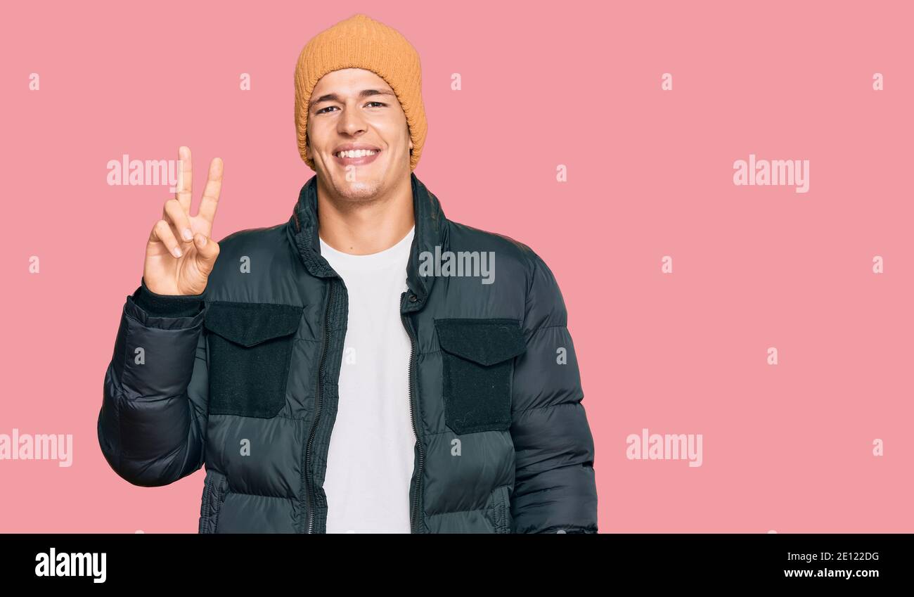 Handsome caucasian man wearing snow wear smiling with happy face ...