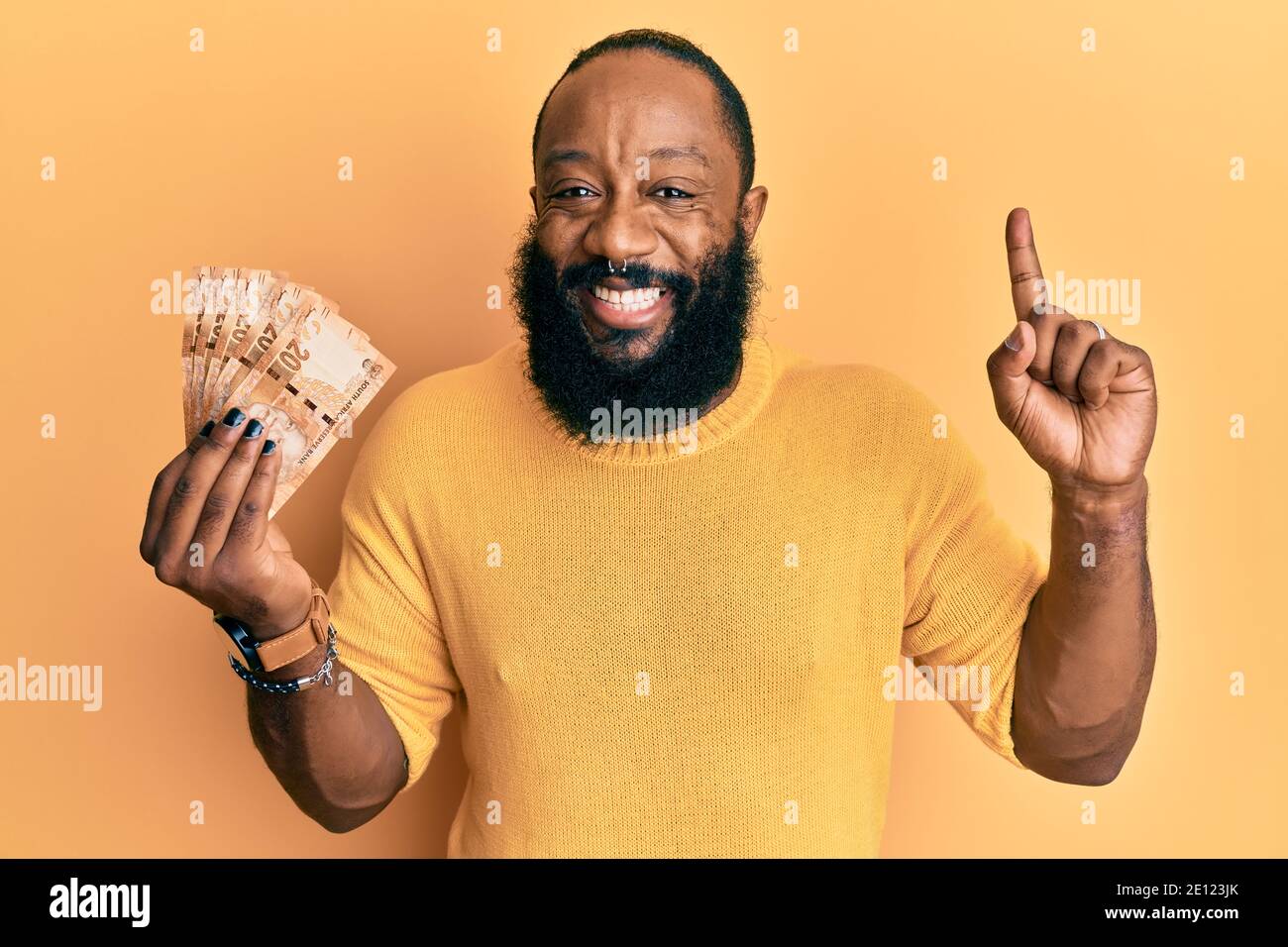 Young african american man holding south african 20 rand banknotes ...