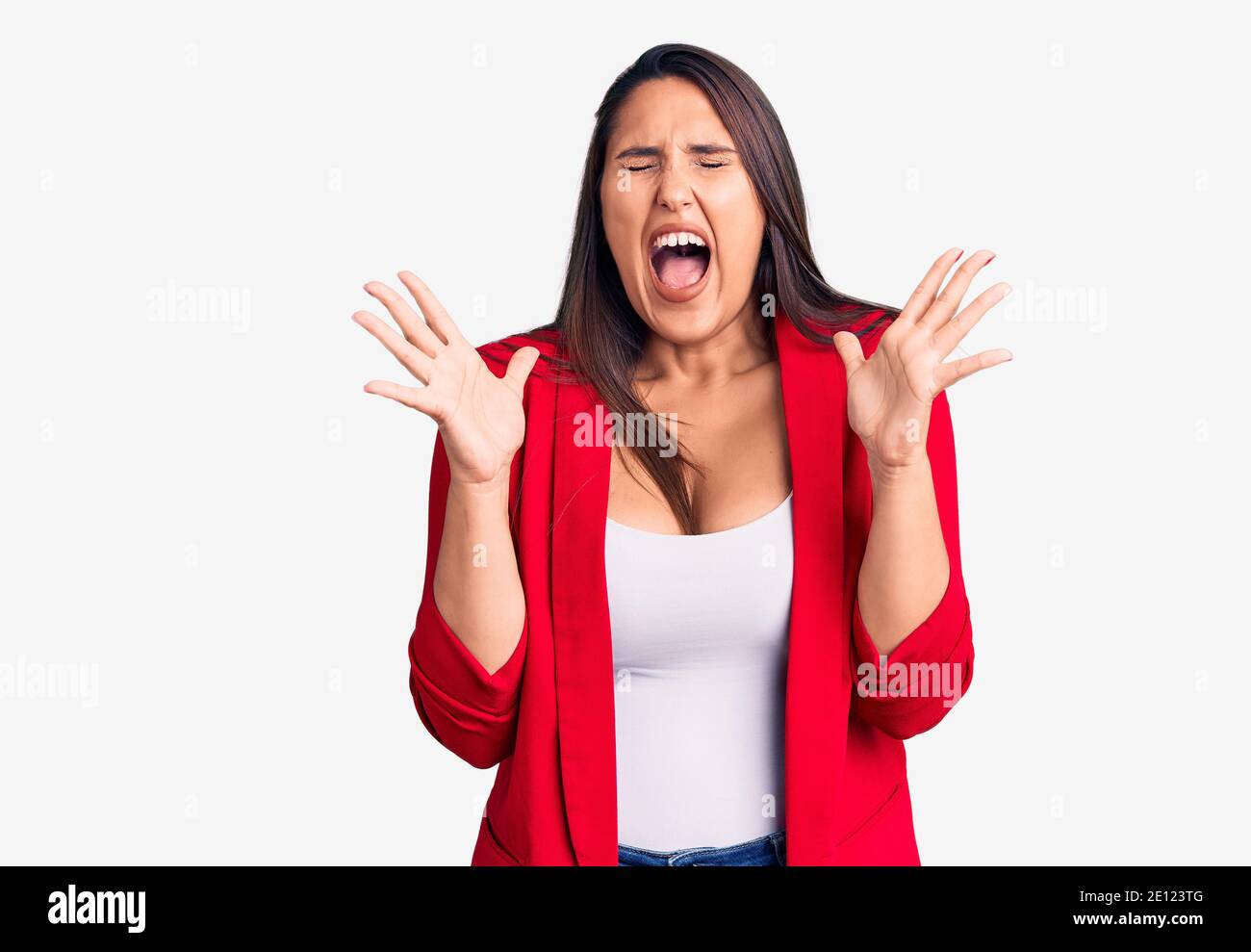Young beautiful brunette woman wearing elegant clothes celebrating mad ...