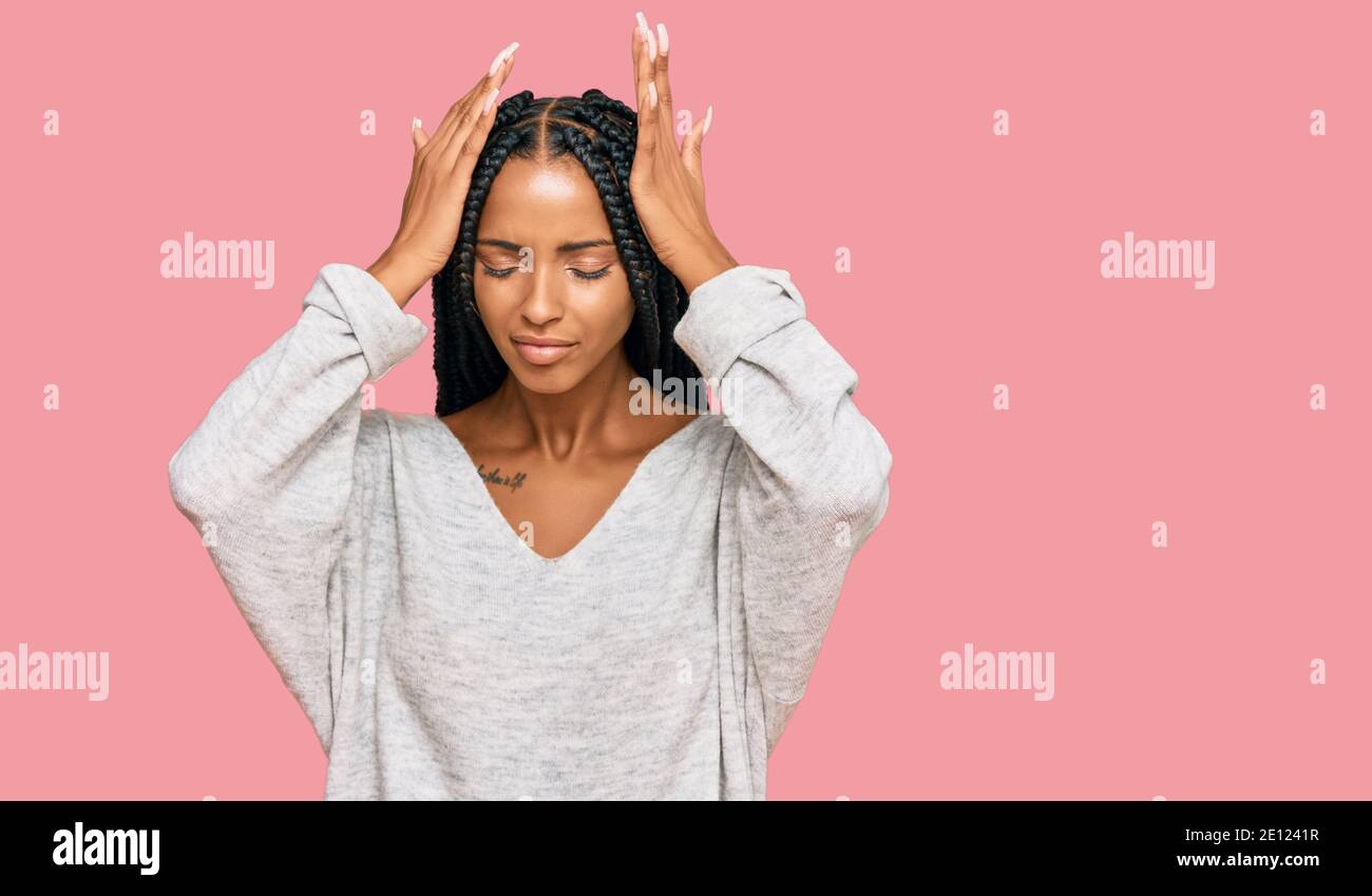 Beautiful hispanic woman wearing casual clothes suffering from headache ...
