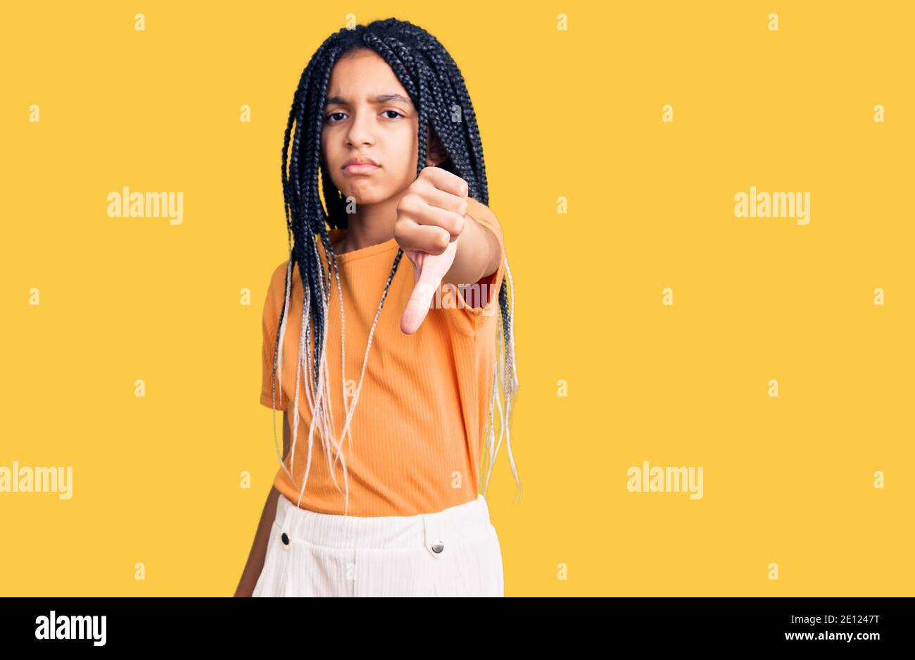Cute african american girl wearing casual clothes looking unhappy and ...