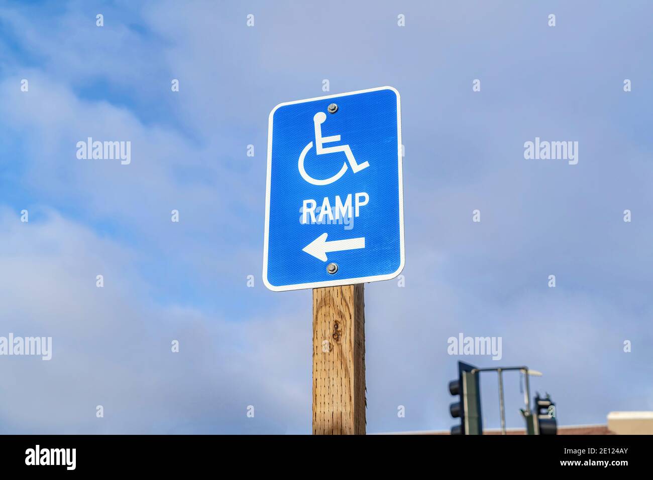 Wheelchair Ramp with arrow sign against cloudy blue sky in San Diego ...