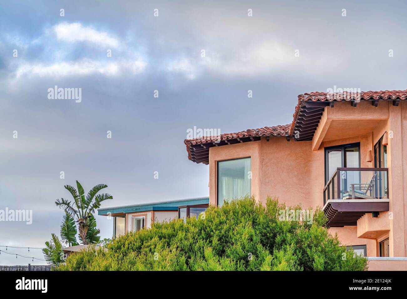 House with balcony tile roof and peach wall with sky background in San ...