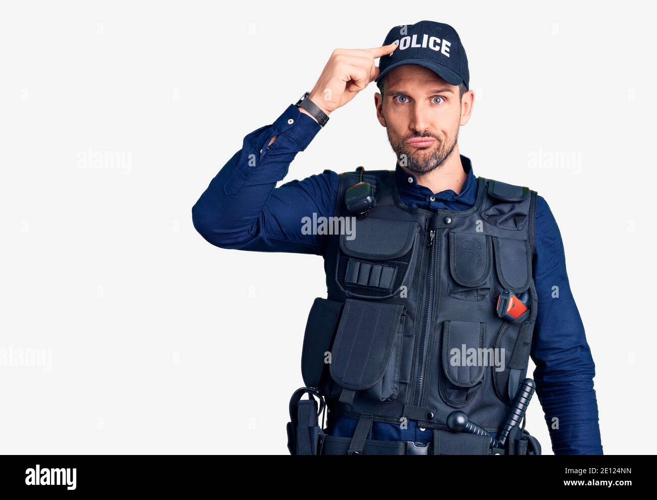 Young handsome man wearing police uniform worried and stressed about a ...
