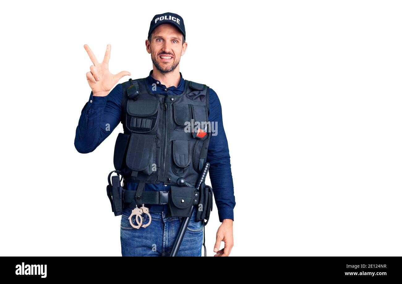 Young handsome man wearing police uniform showing and pointing up with ...