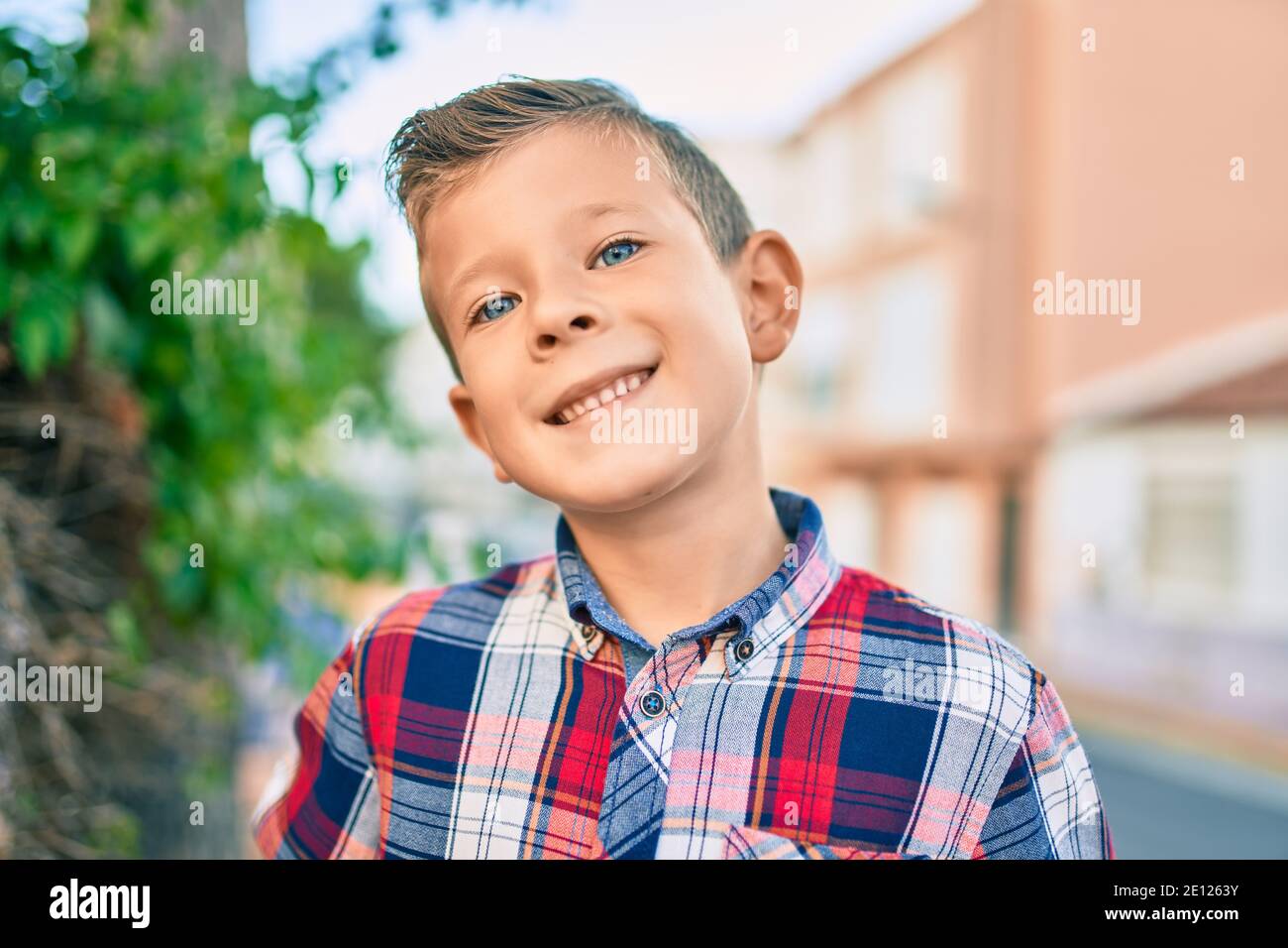Adorable caucasian boy smiling happy standing at the city Stock Photo - Alamy
