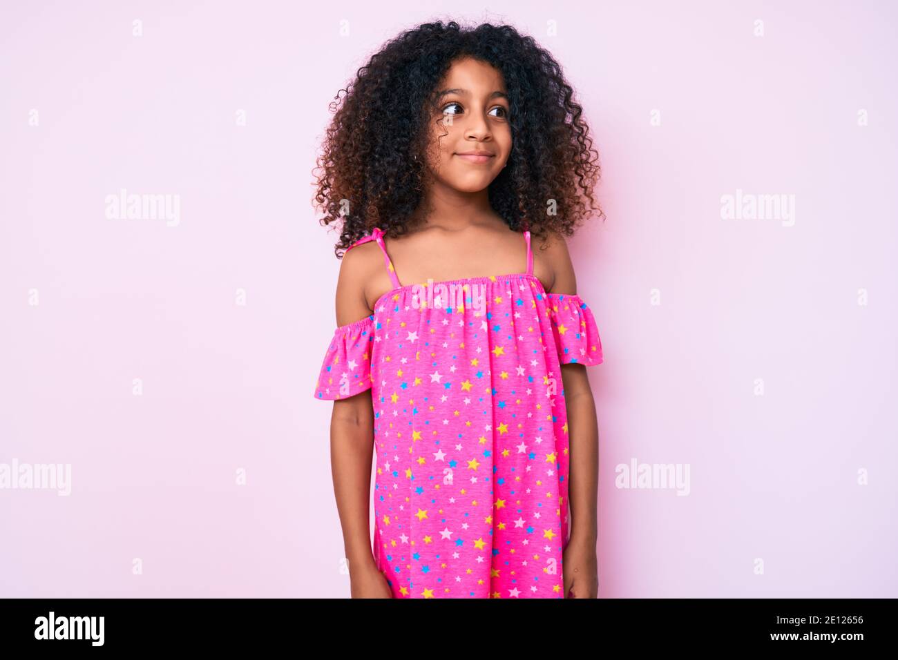 African american child with curly hair wearing casual dress smiling ...