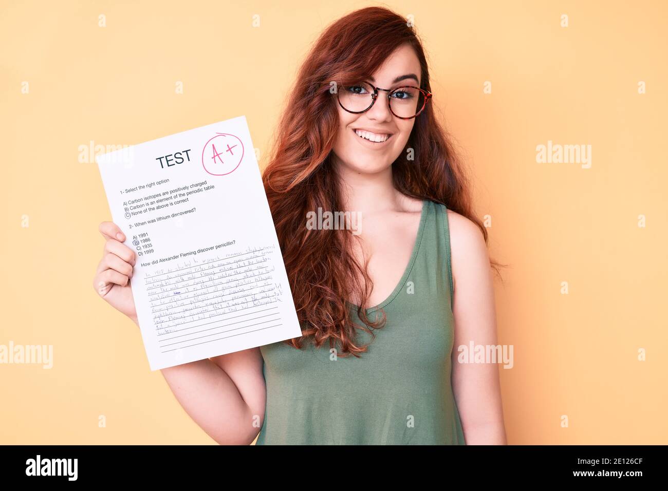 Young beautiful woman showing a passed exam looking positive and happy ...