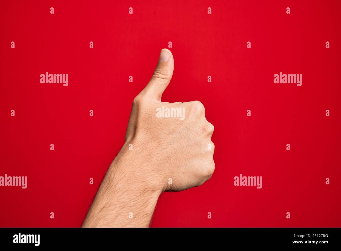 Hand of caucasian young man showing fingers over isolated red ...