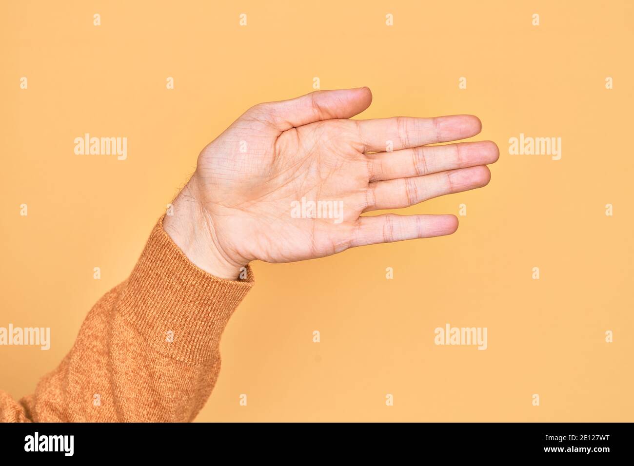Hand of caucasian young man showing fingers over isolated yellow ...