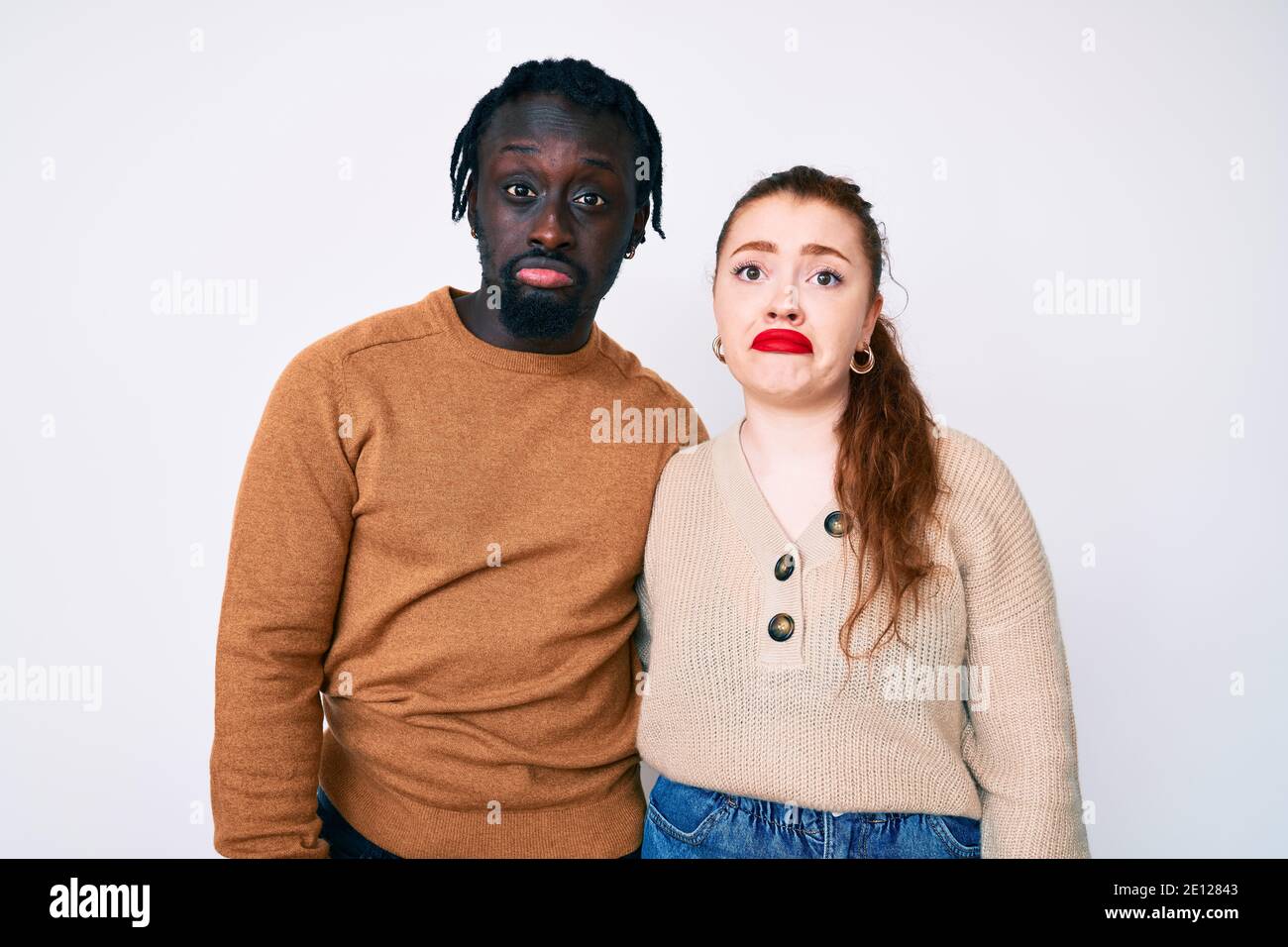 Interracial Couple Wearing Casual Clothes Depressed And Worry For