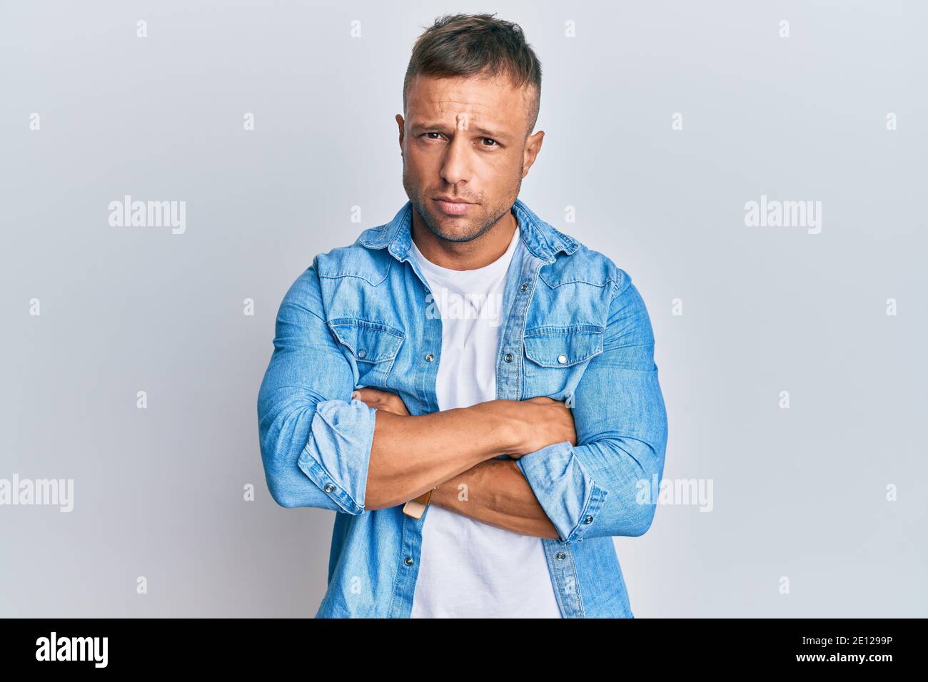 Handsome muscle man wearing casual denim jacket skeptic and nervous ...