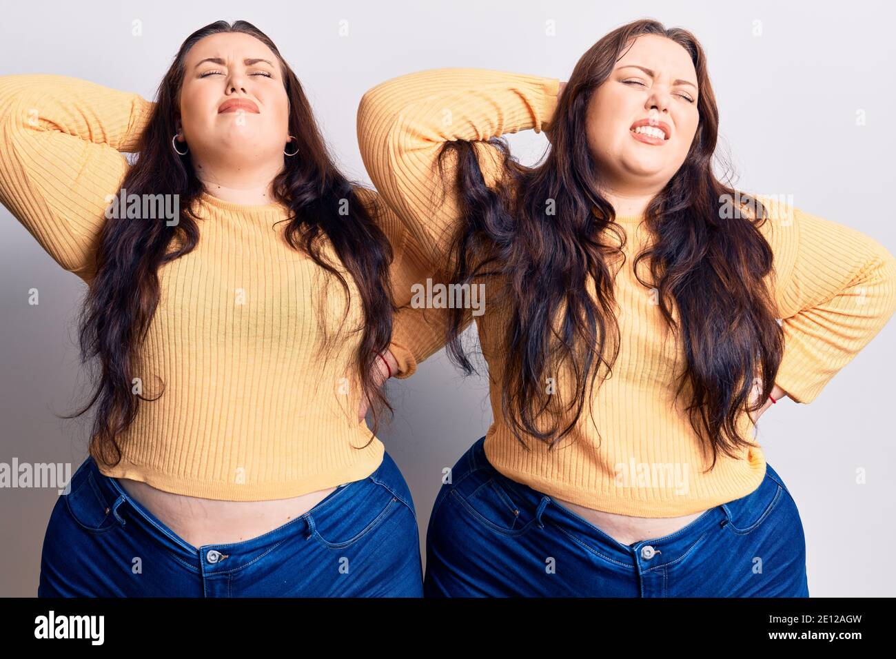 Young plus size twins wearing casual clothes suffering of neck ache ...
