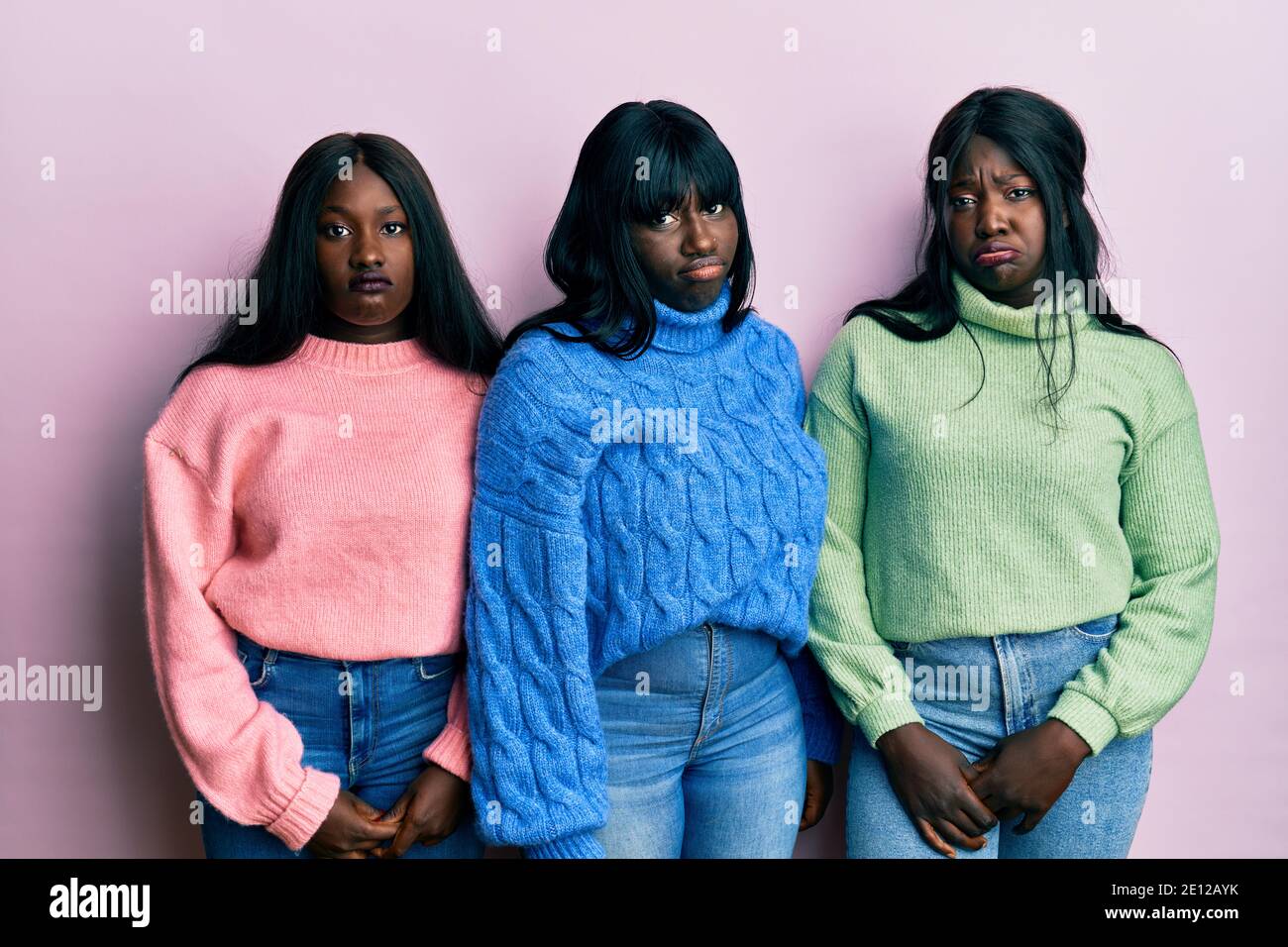 Three young african american friends wearing wool winter sweater ...