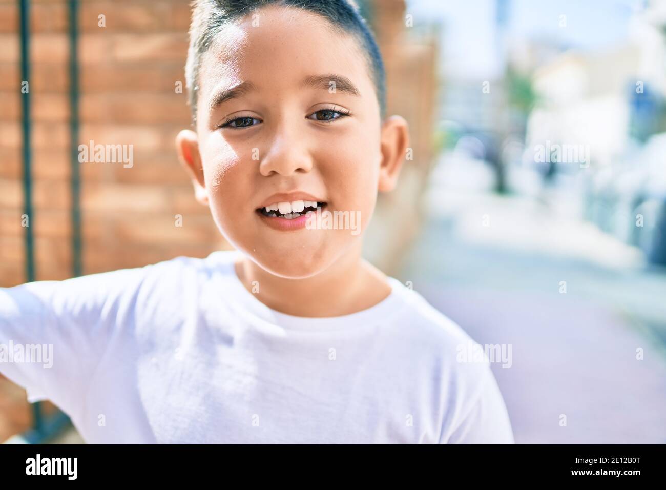 Adorable boy smiling happy standing at street of city Stock Photo - Alamy