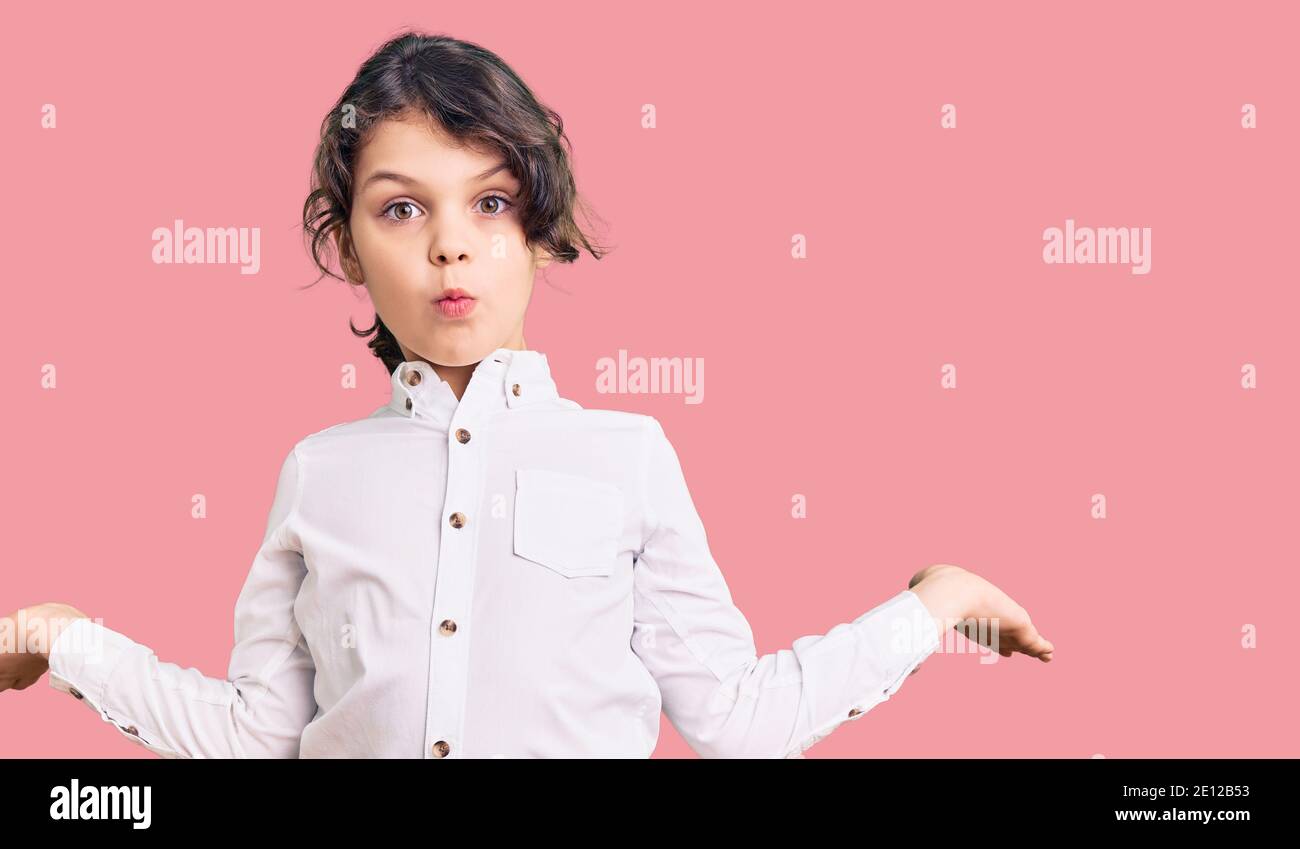 Cute hispanic child wearing casual clothes clueless and confused ...
