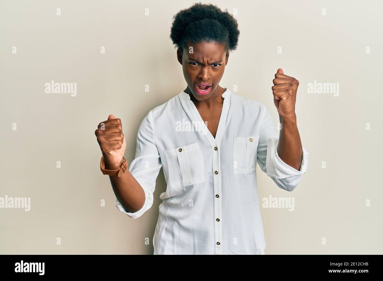 Young african american girl wearing casual clothes angry and mad ...