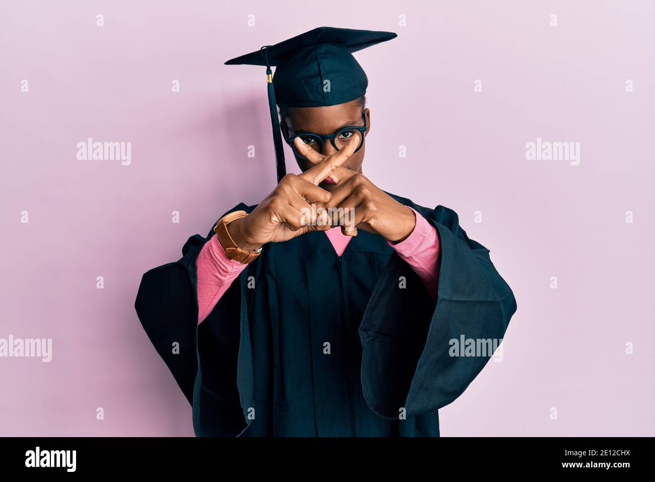 Young african american girl wearing graduation cap and ceremony robe ...